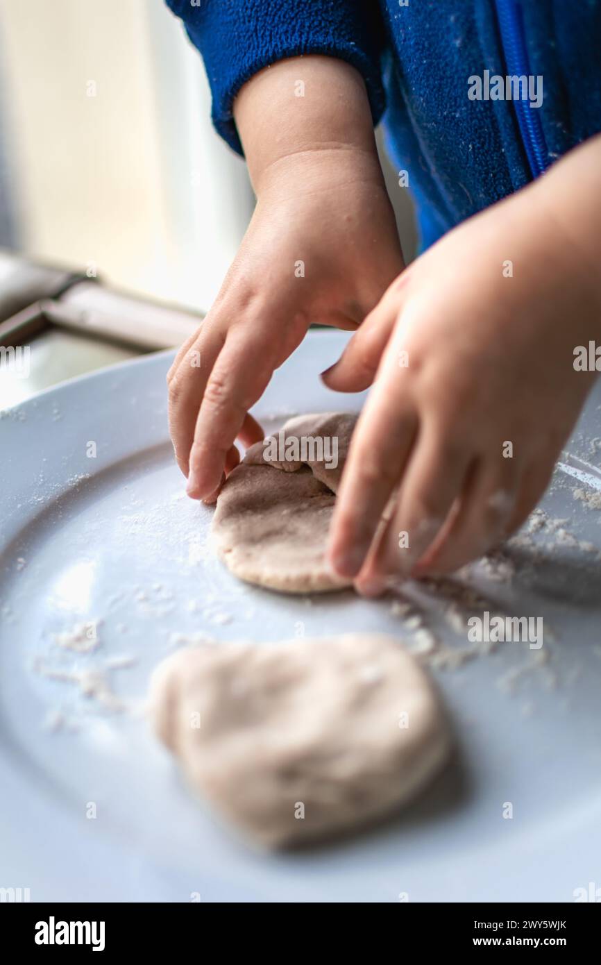 Child having fun modeling dough, authentic activity for fine motor ...