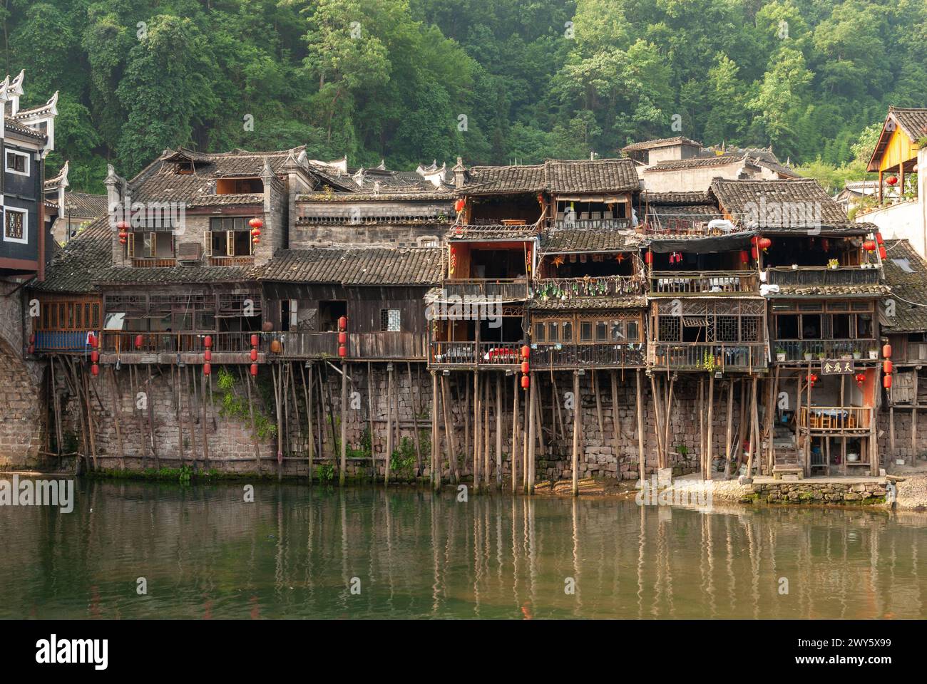 The old wooden buildings on the edge of the river in Fenghuang, an ...