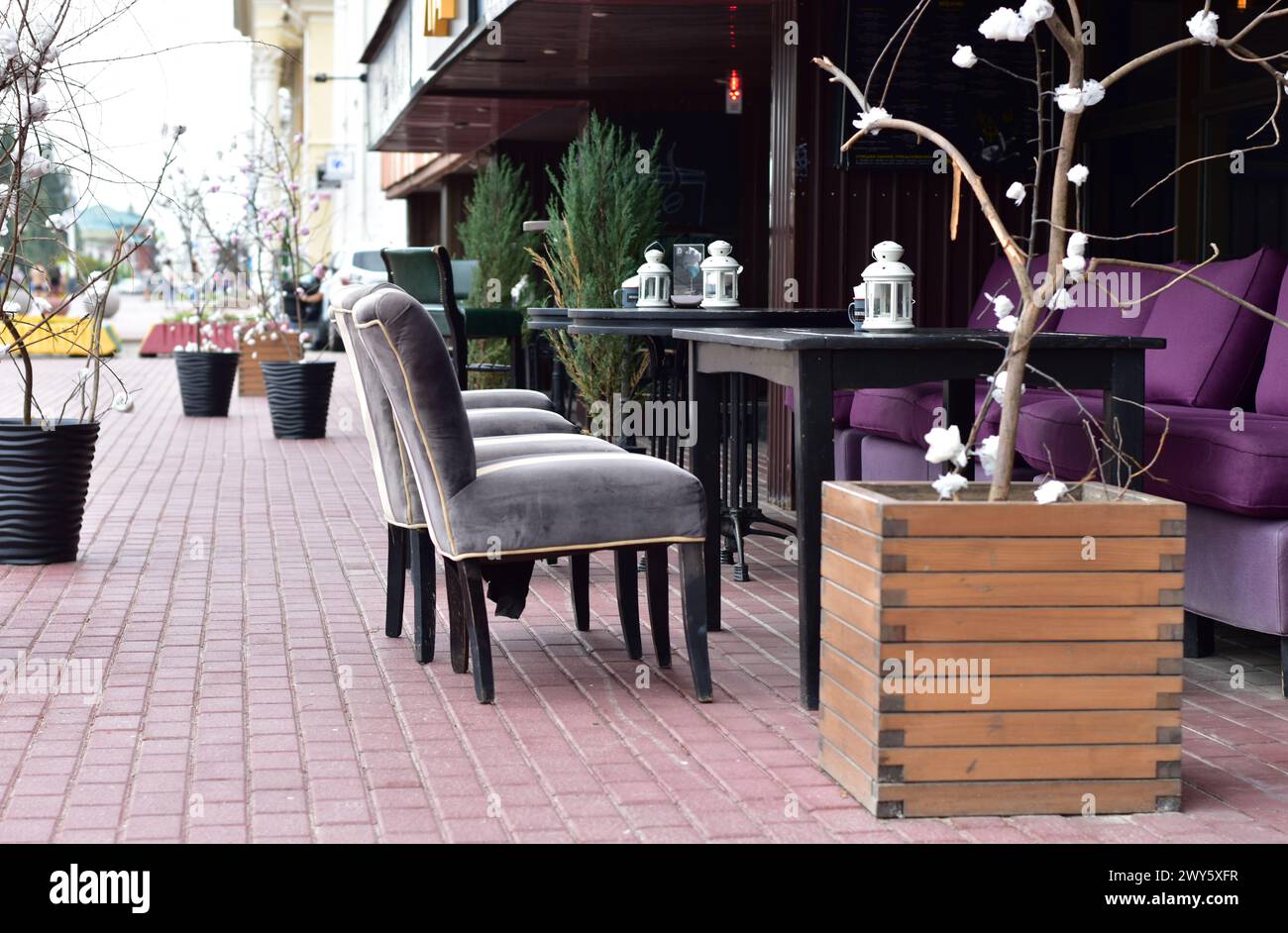 Chairs and tables of a street cafe in the early morning without ...