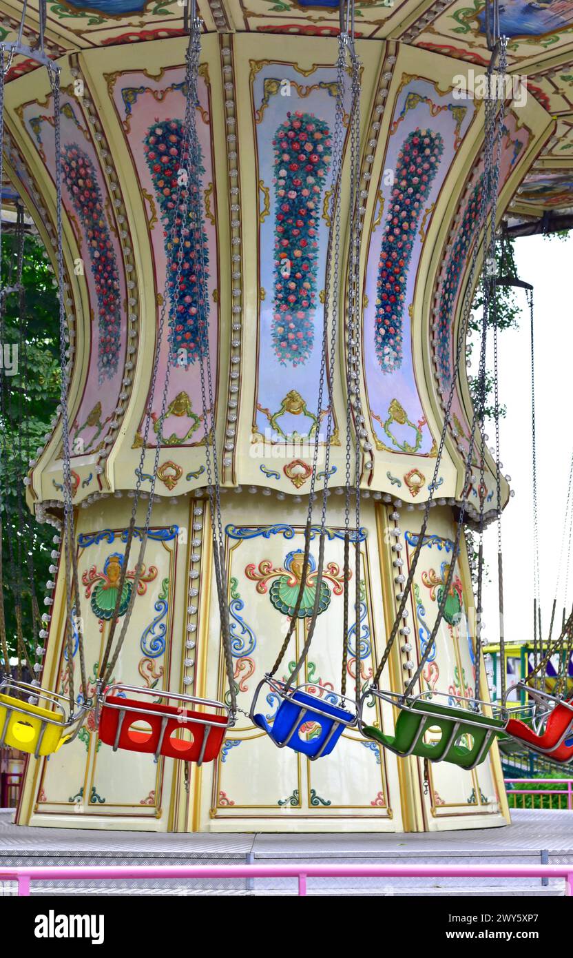 The picture shows the carousel in a calm state with the seats hanging ...