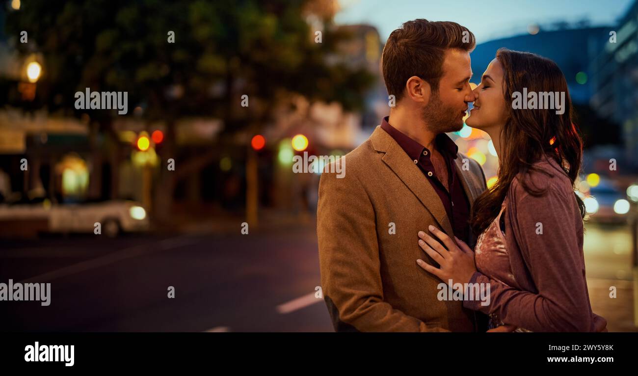 Couple, night and city with hug and kiss on date, romance and bonding ...