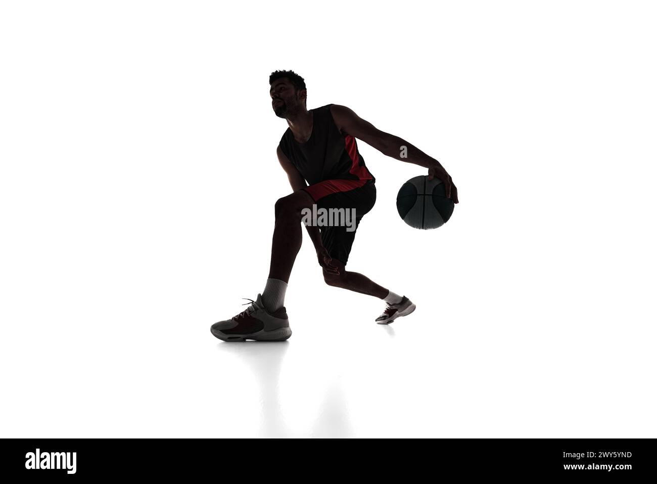 Silhouette of concentrated male athlete, basketball player in motion ...