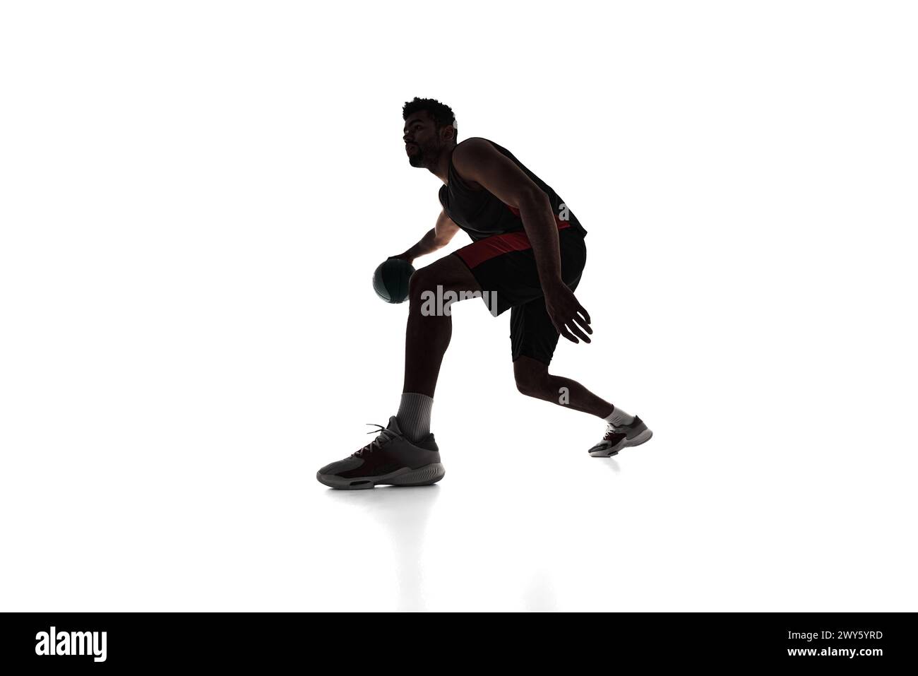 Silhouette of concentrated male athlete, basketball player in motion ...