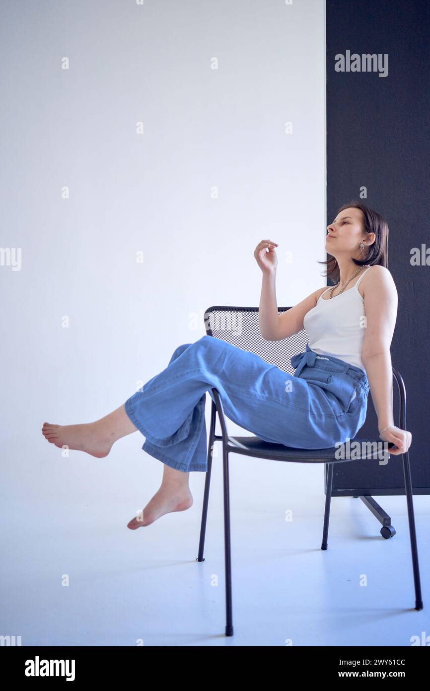 a young teenage girl fighting brain cancer sitting on black chair on ...
