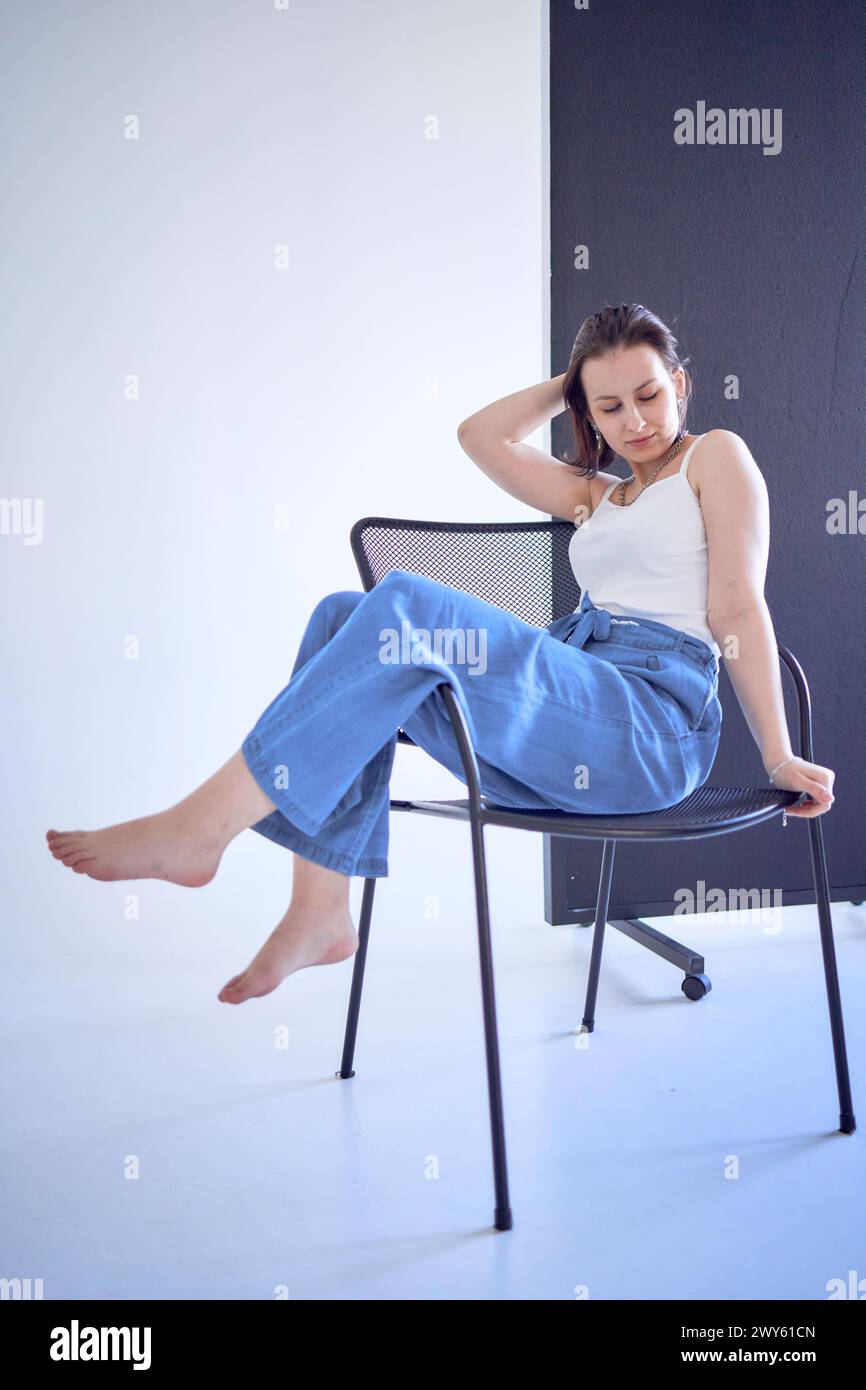 a young teenage girl fighting brain cancer sitting on black chair on ...
