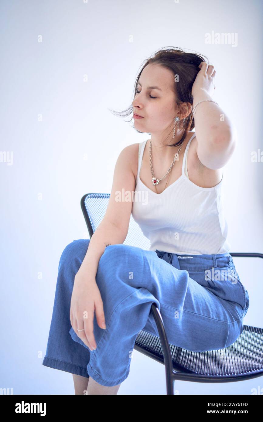a young teenage girl fighting brain cancer sitting on black chair on ...