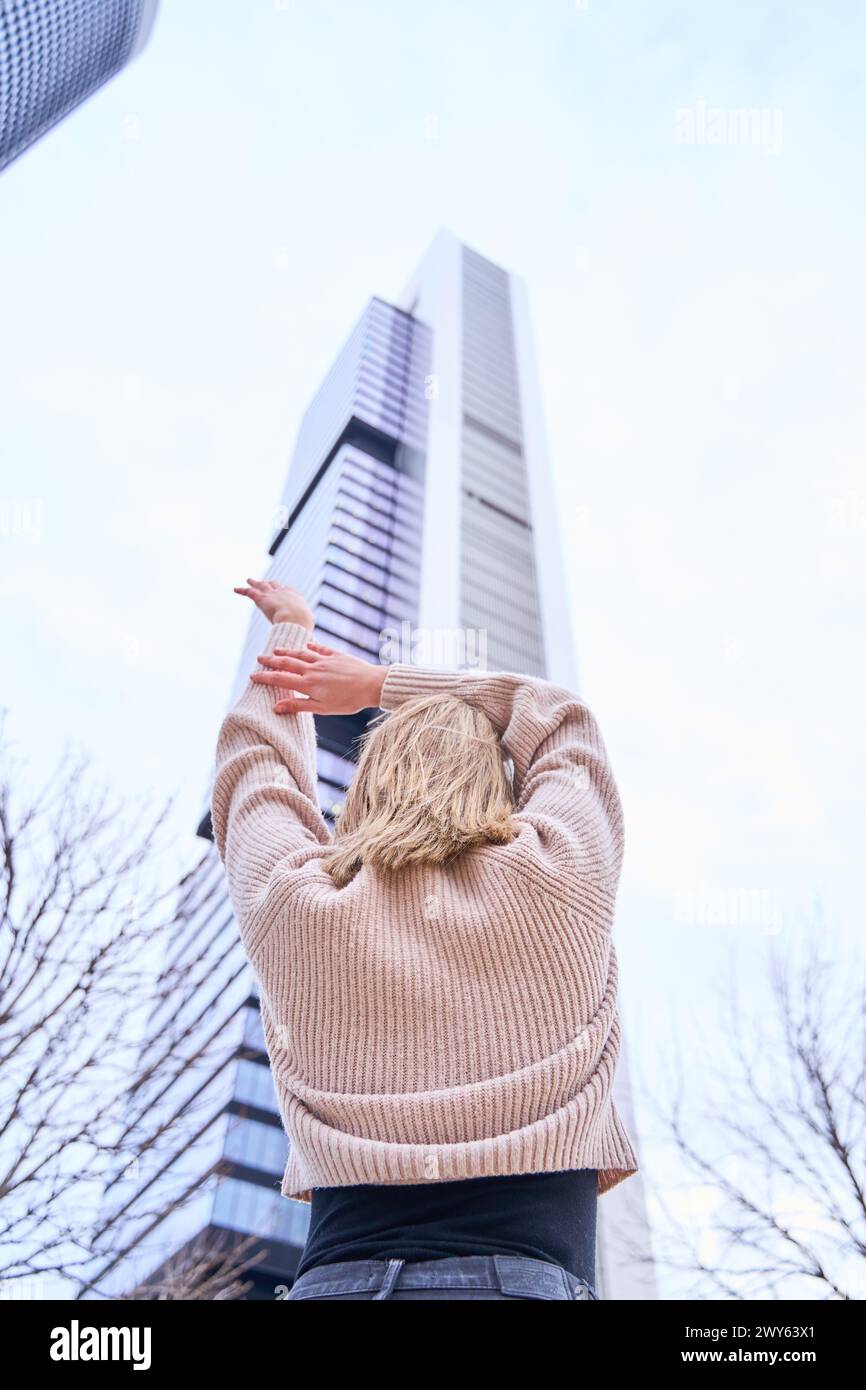woman on her back in the city raising her arms over her head Stock ...