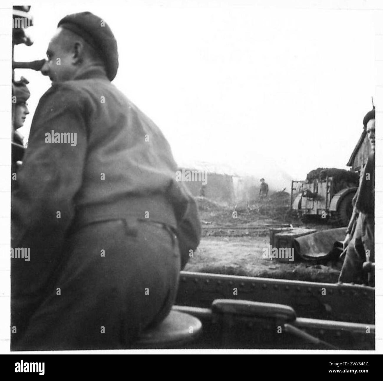 12 CORPS ADVANCE - 25-pdr guns in foreground and burning buildings in ...