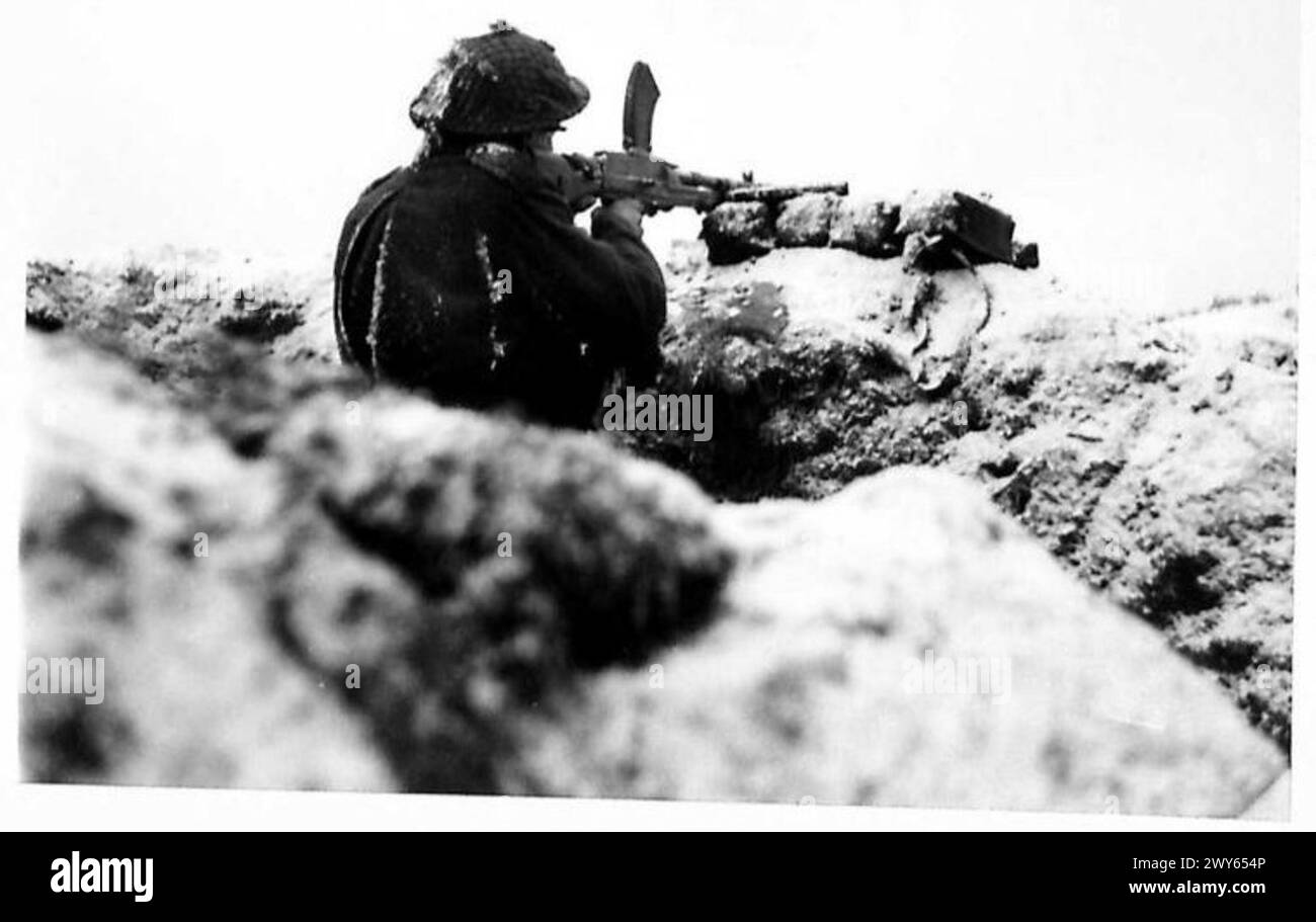 A Bren-gunner from the 52nd Division observes No-Man's Land covered in ...