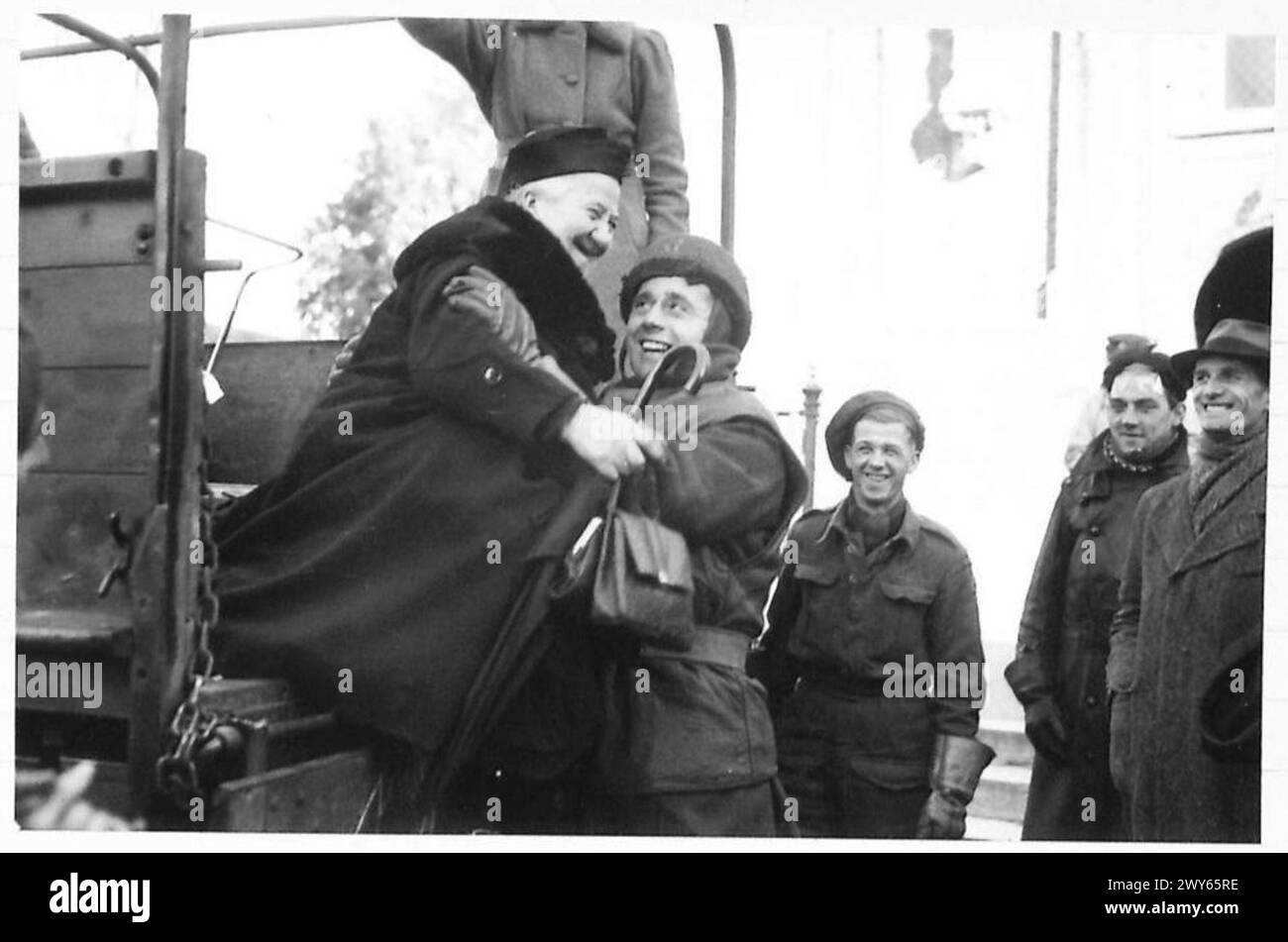 A Dutch evacuee woman is assisted by a British soldier as she ...