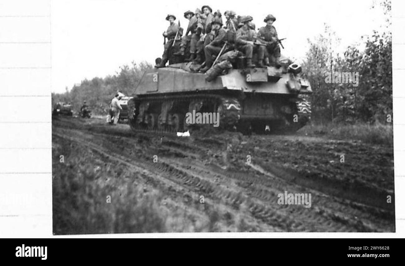 29 ARMOURED BDE. - Tanks on the move West of Venray, with infantry in ...
