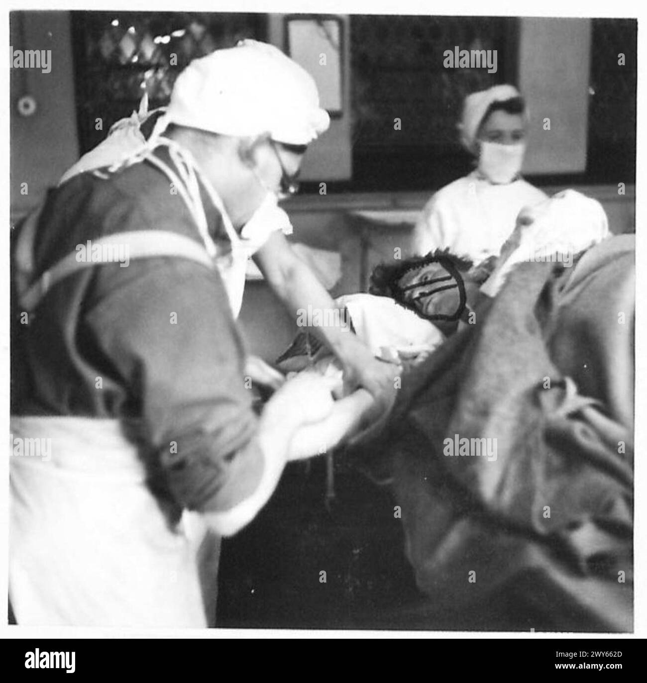 A patient with a leg severely damaged by shrapnel receives medical ...