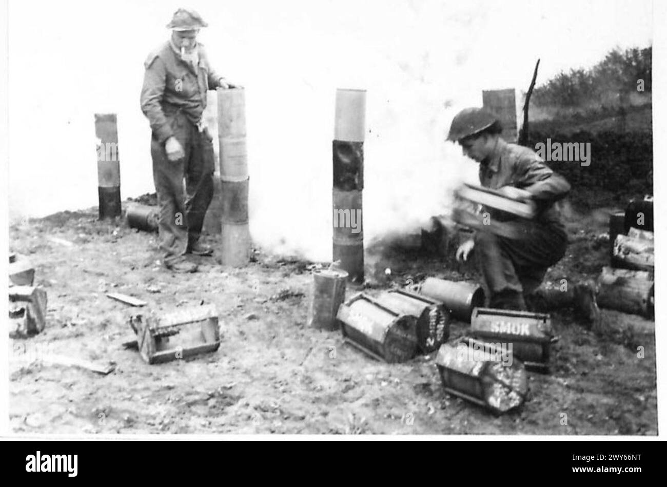 Pte. E. Salmon and Pte. R. Clark unpack smoke generators for creating a ...
