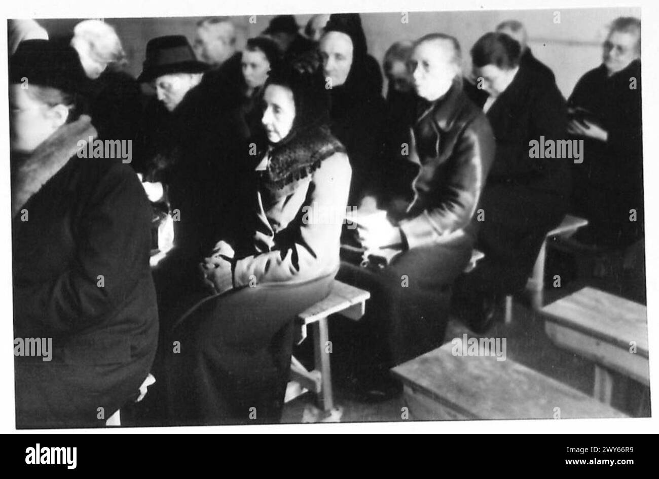 Aged German women are pictured praying during civilian evacuation from ...