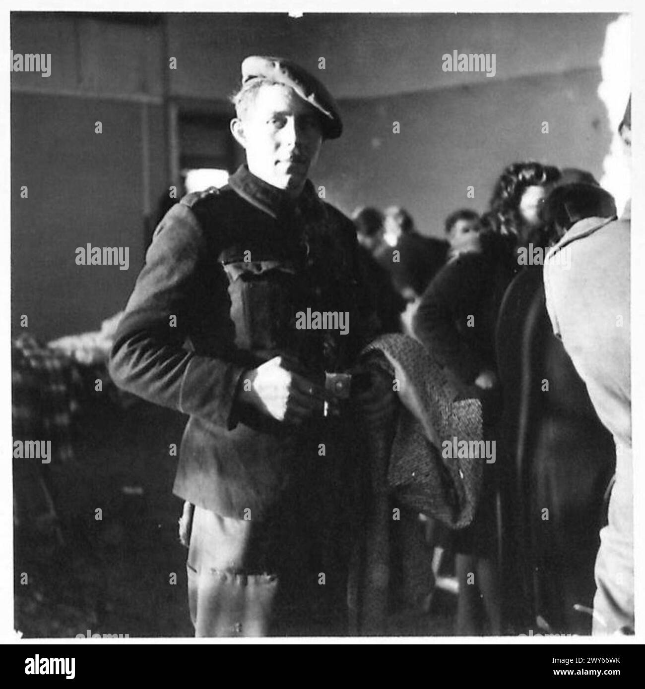 ALLIED CLOTHING FOR DUTCH - Underground worker collects new coat for ...
