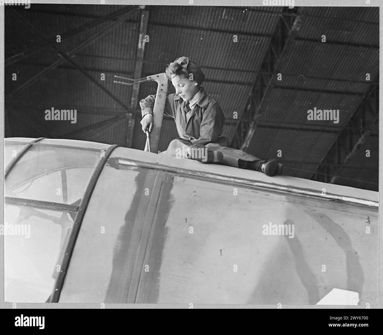 Photograph shows a W.A.A.F. instrument mechanic performing an inter ...
