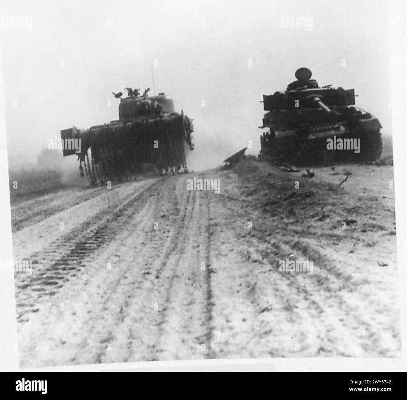 THE OFFENSIVE CONTINUES IN NORMANDY - A Sherman tank with flails goes ...