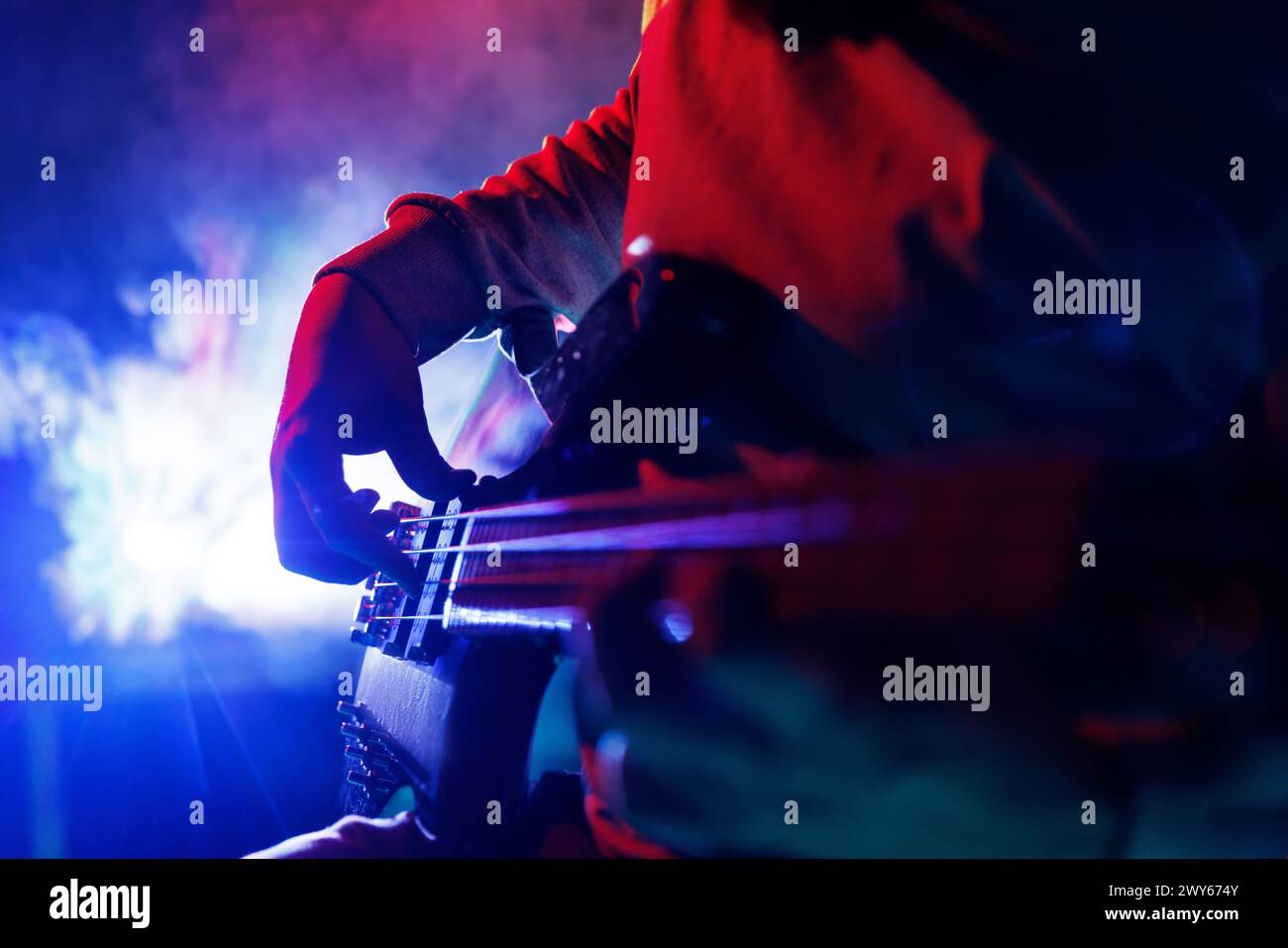 Electric guitar played by professional, talented guitarist under blue ...