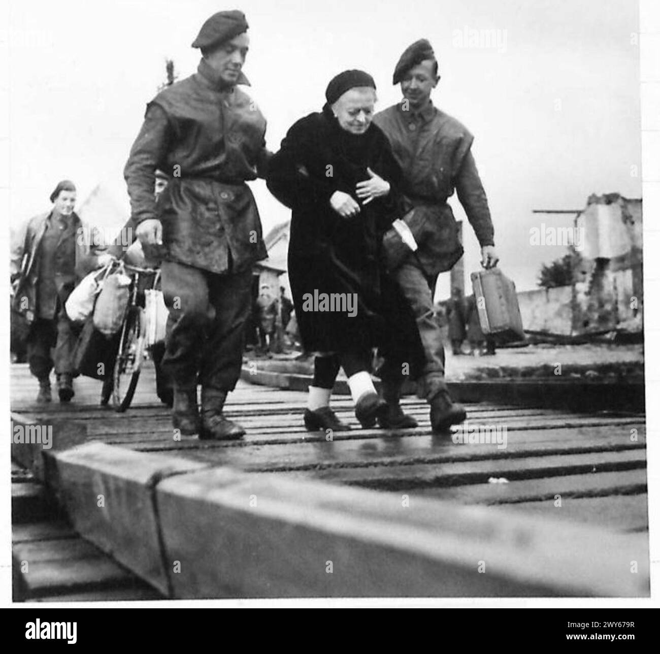 Photograph shows refugees crossing the canal at Grande Mille Bruggke ...