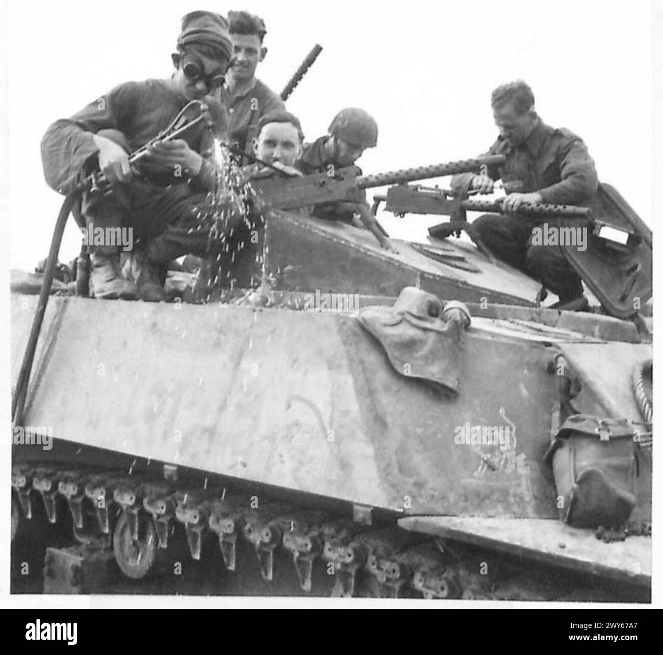 A welder repairs the turret of a Stewart Recce tank of 13 A/Hussars, 27 ...