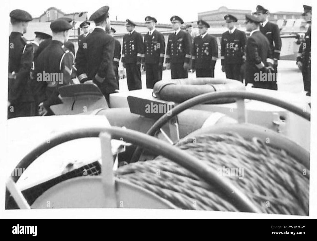 British naval officers inspect German cruisers, standing opposite ...