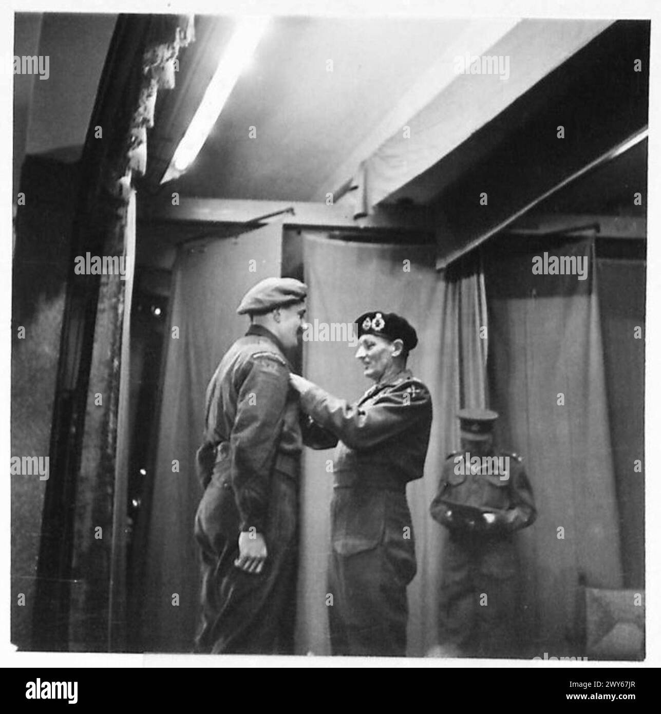 Gunner A. Carmichael of the 53rd Division Signals is awarded the ...