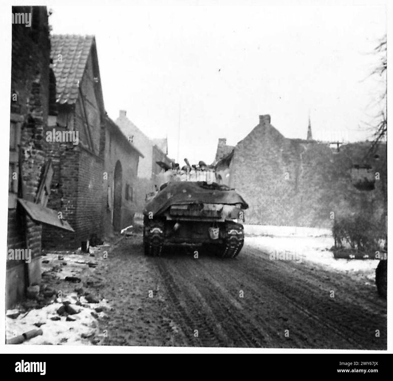 12 CORPS ATTACK - Sherman tank advancing along the streets of Saeffelen ...
