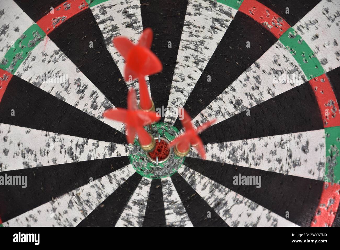 Bullseye with darts piercing the center of the dartboard Stock Photo ...
