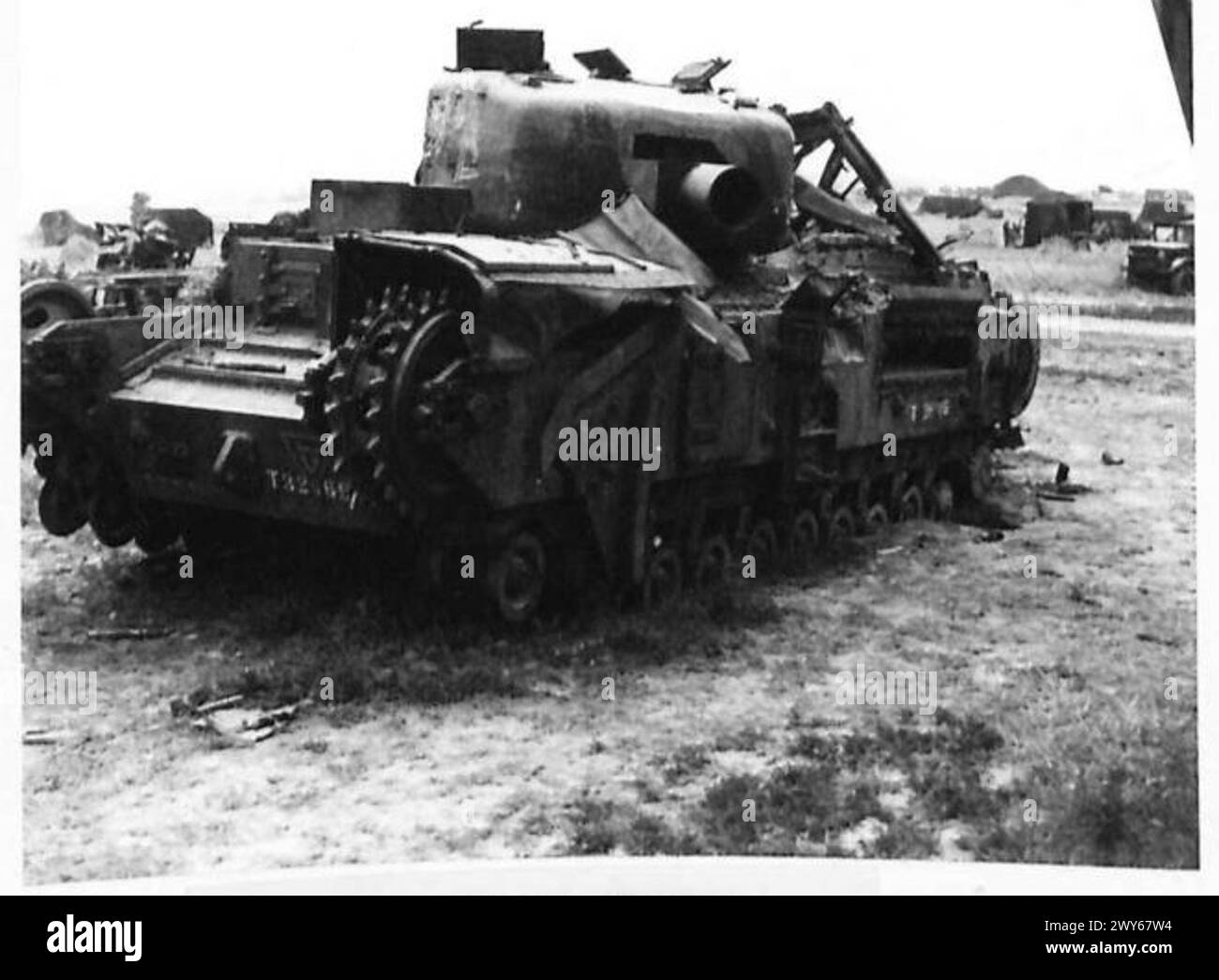 A DUMP FOR DAMAGED VEHICLES IN NORMANDY - A damaged Churchill tank ...
