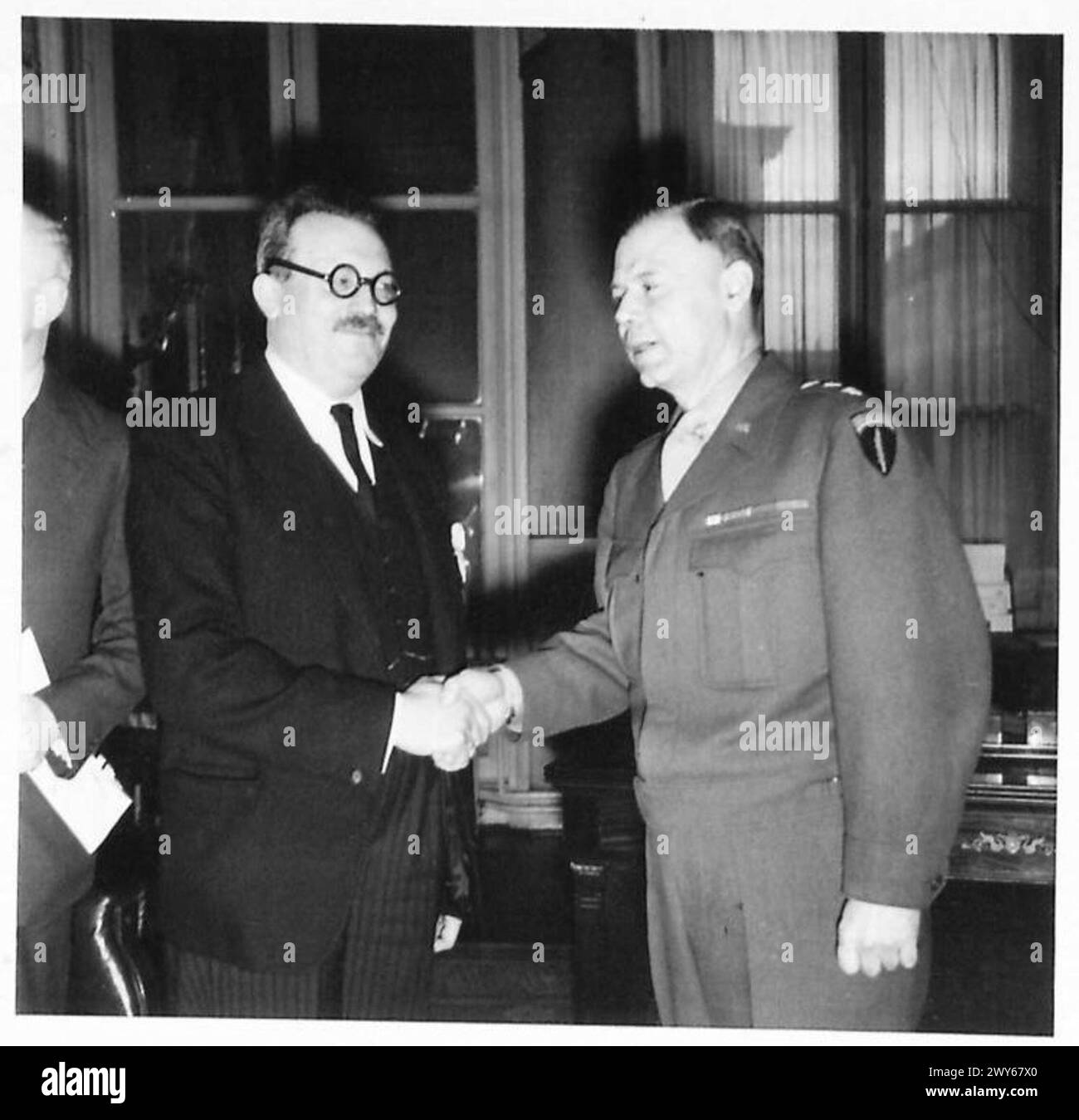 SHAEF VISIT TO BELGIAN PREMIER - L-R:- Lt-Gen W.B. Smith met by M. Van ...