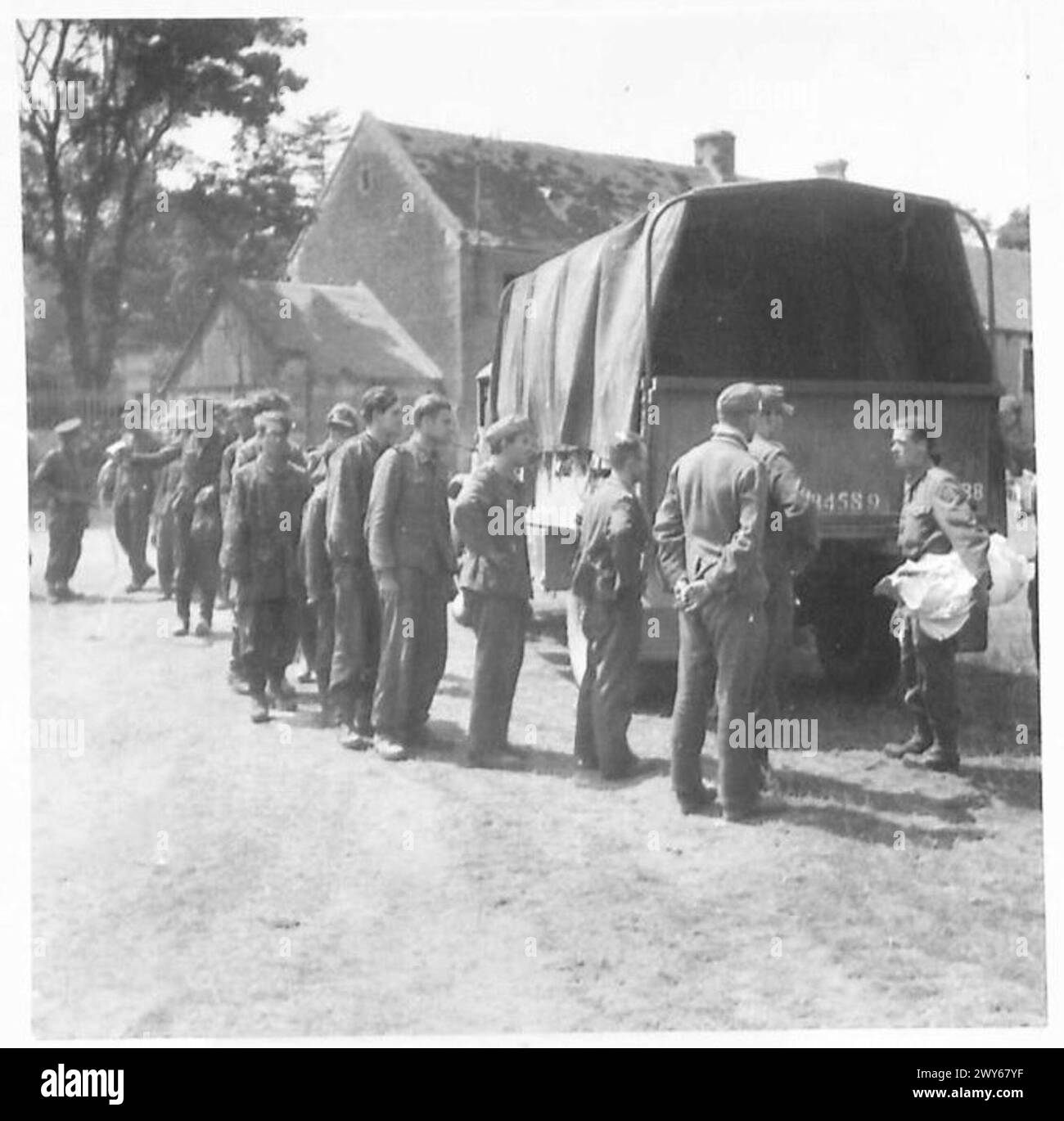 German prisoners of war are transported by truck to a POW cage from ...