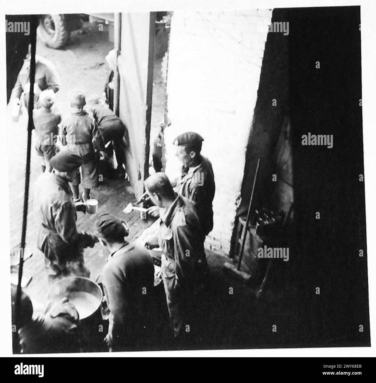 SOLDIERS IN A DUTCH WINDMILL. - The men gather round the mill for their ...