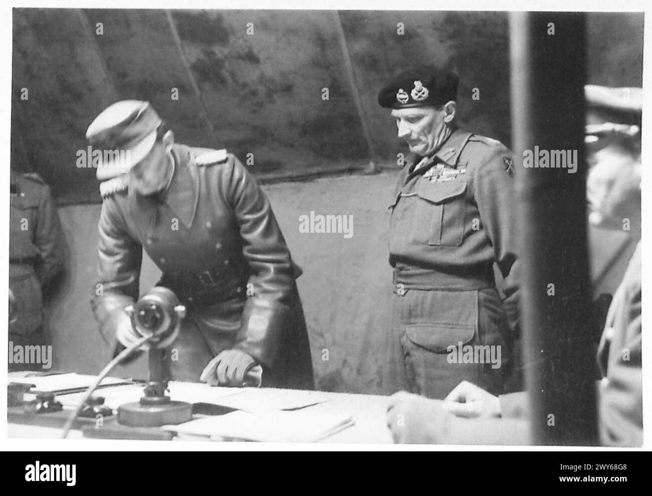 Colonel Poleck of the German Supreme Command signs surrender terms on ...