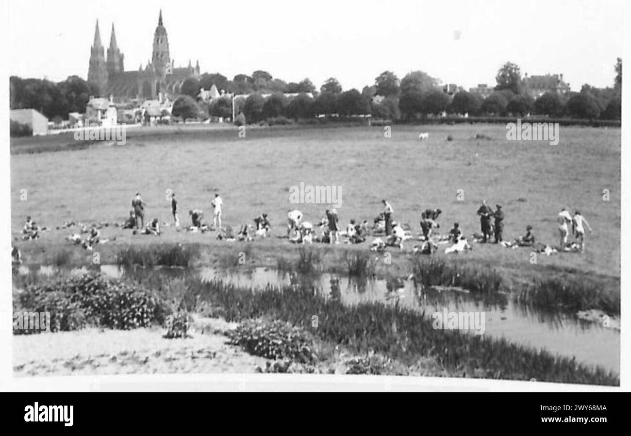 British soldiers bathe in the river Aure at Bayeux, Normandy, with the ...