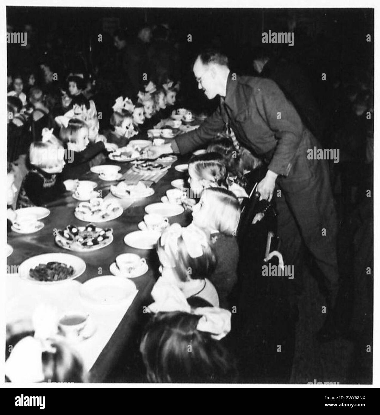 TROOPS GOODWILL PARTY TO DUTCH CHILDREN - Soldiers helping the children ...