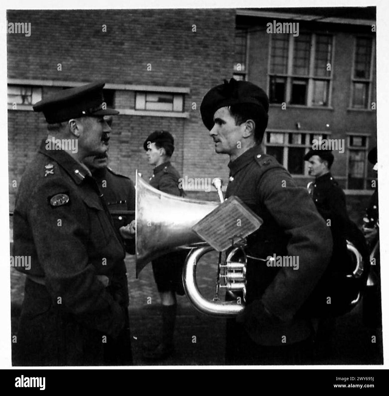 Lieutenant-General Ritchie speaks with Bandsman Hussey of Watford, who ...
