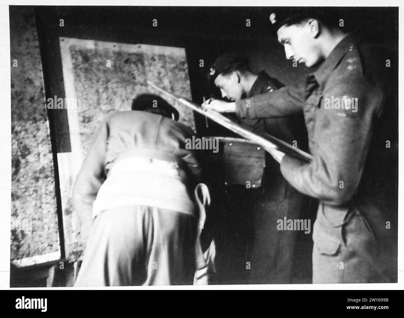 CHECKING LOCATIONS - British officer rounds a map taking notes of ...