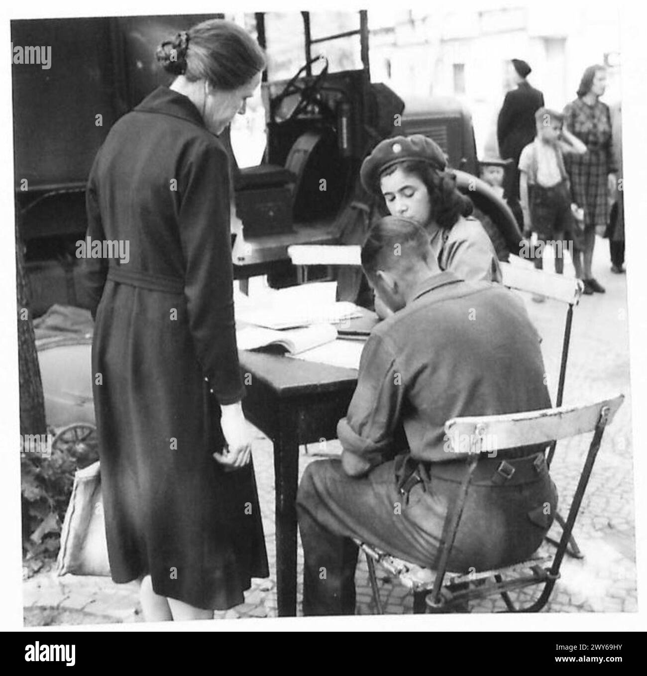 A German woman provides her age and employment information to the ...