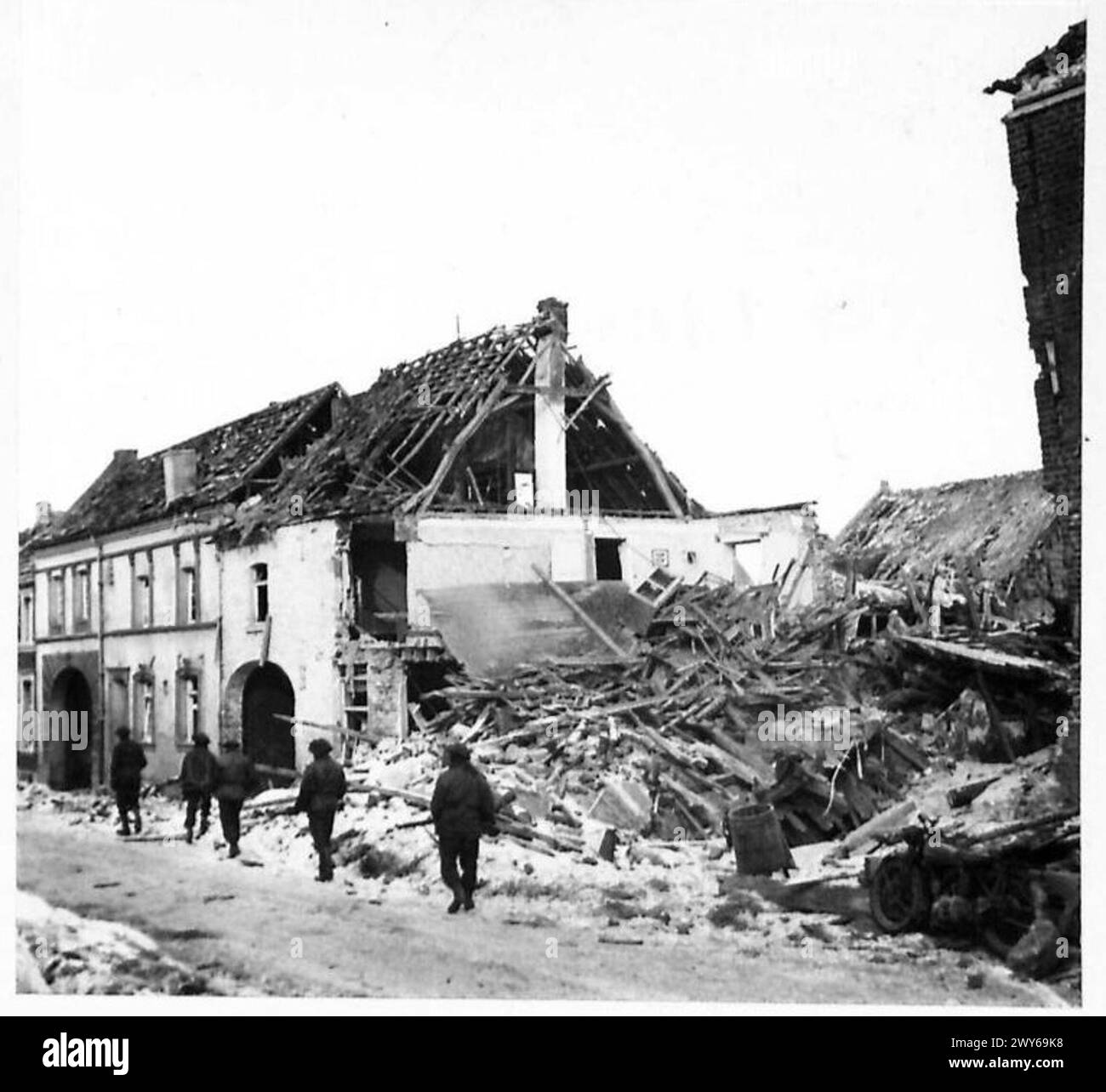 THE FALL OF WALDFEUCHT - A patrol of the 4th Bn KOSB passing damaged ...