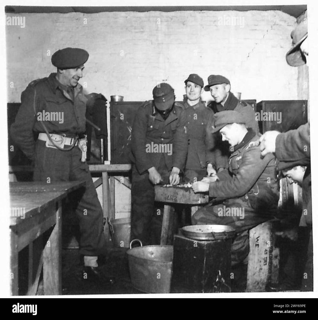PS. C W - British Officer inspecting cookhouse stops to chat and laught ...