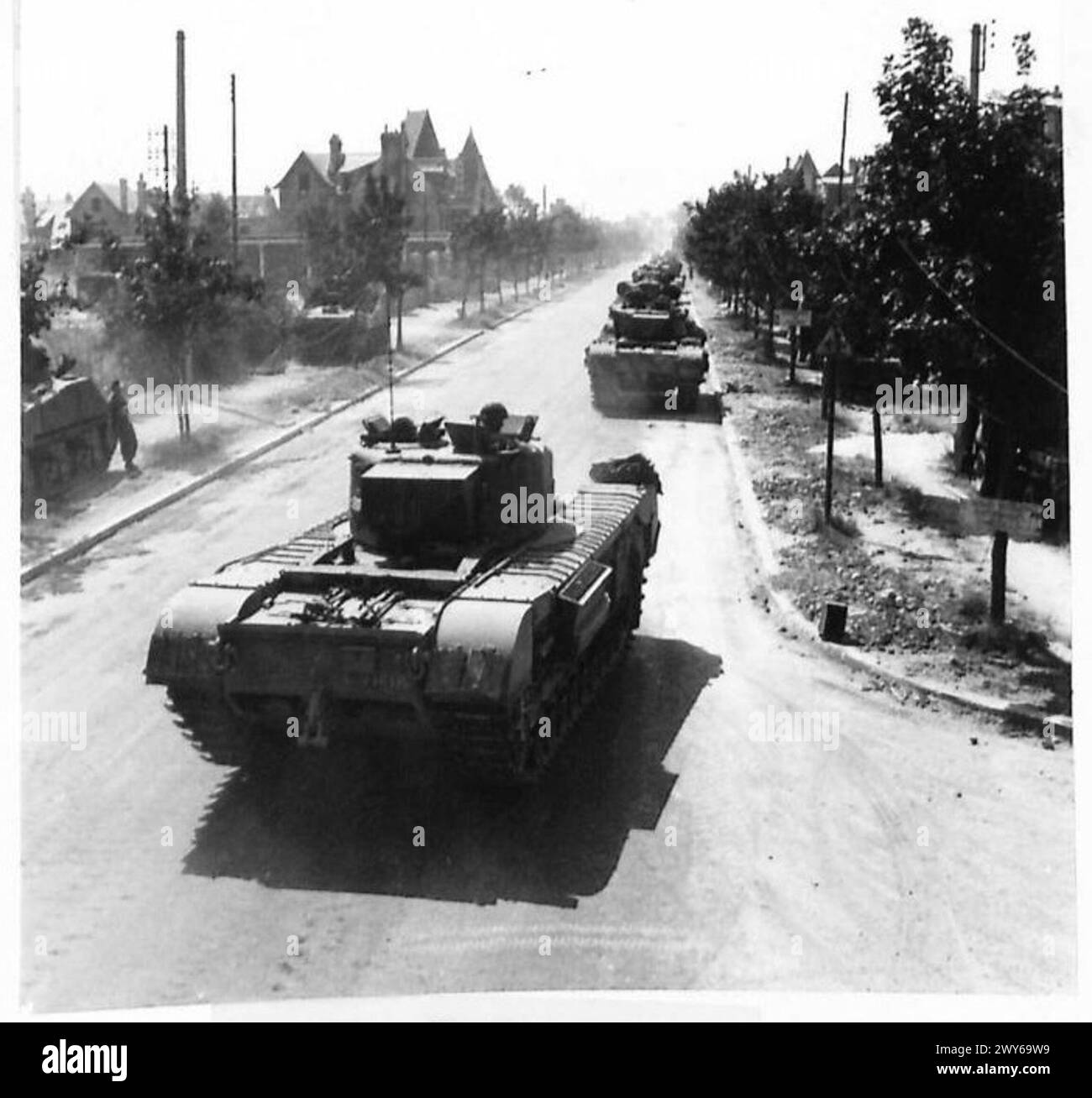 Churchill tanks advance through Vancelles following a 1,000-bomber raid ...