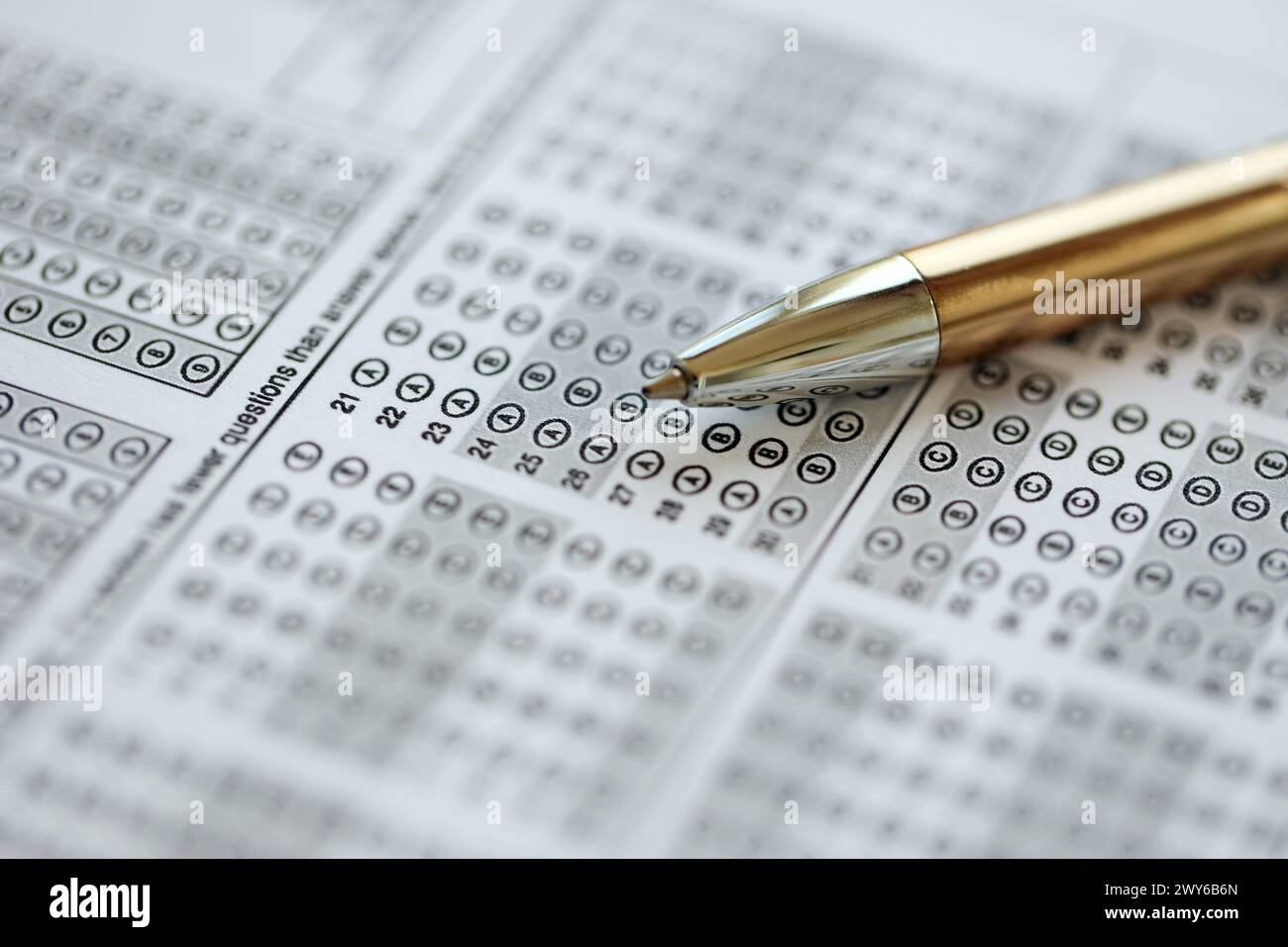 Blank educational test for students lies on table in classroom with pen ...