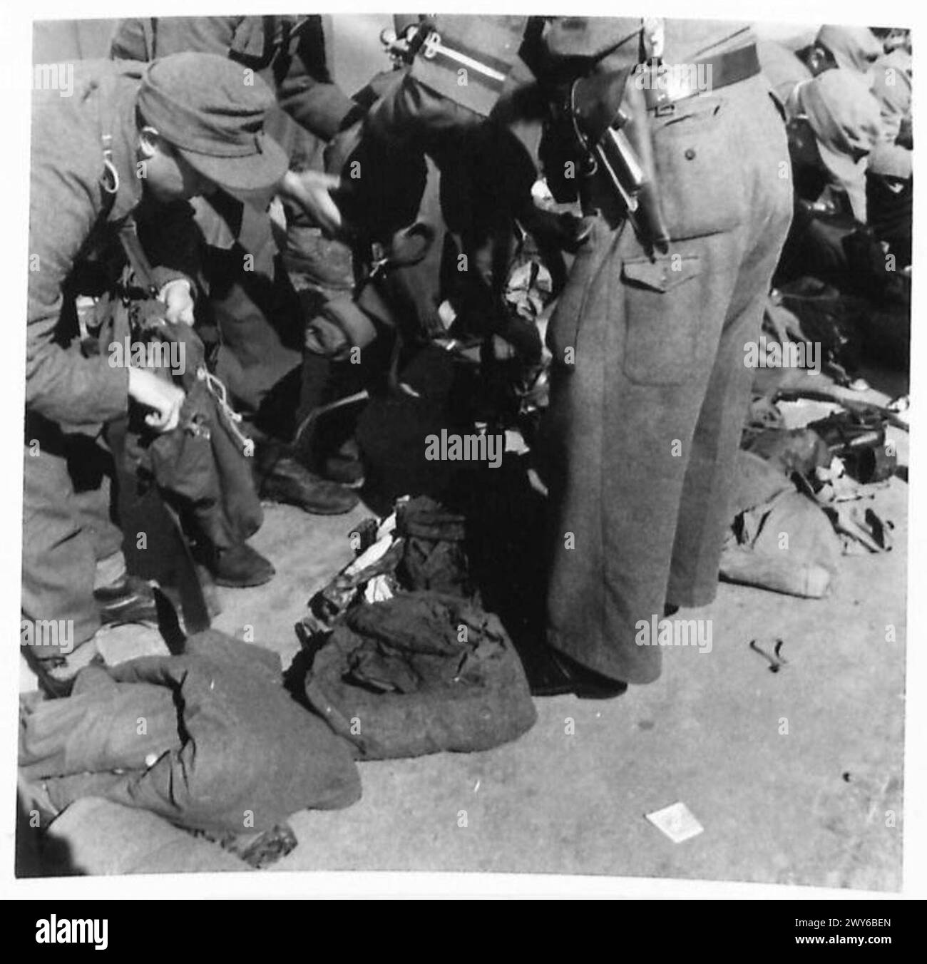 German S.S. regiment troops are searched upon reaching the frontier ...