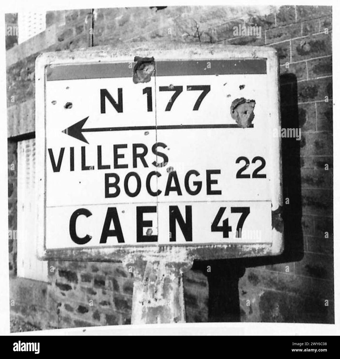 On the road to Vire, a signpost shows the distance advanced by British ...