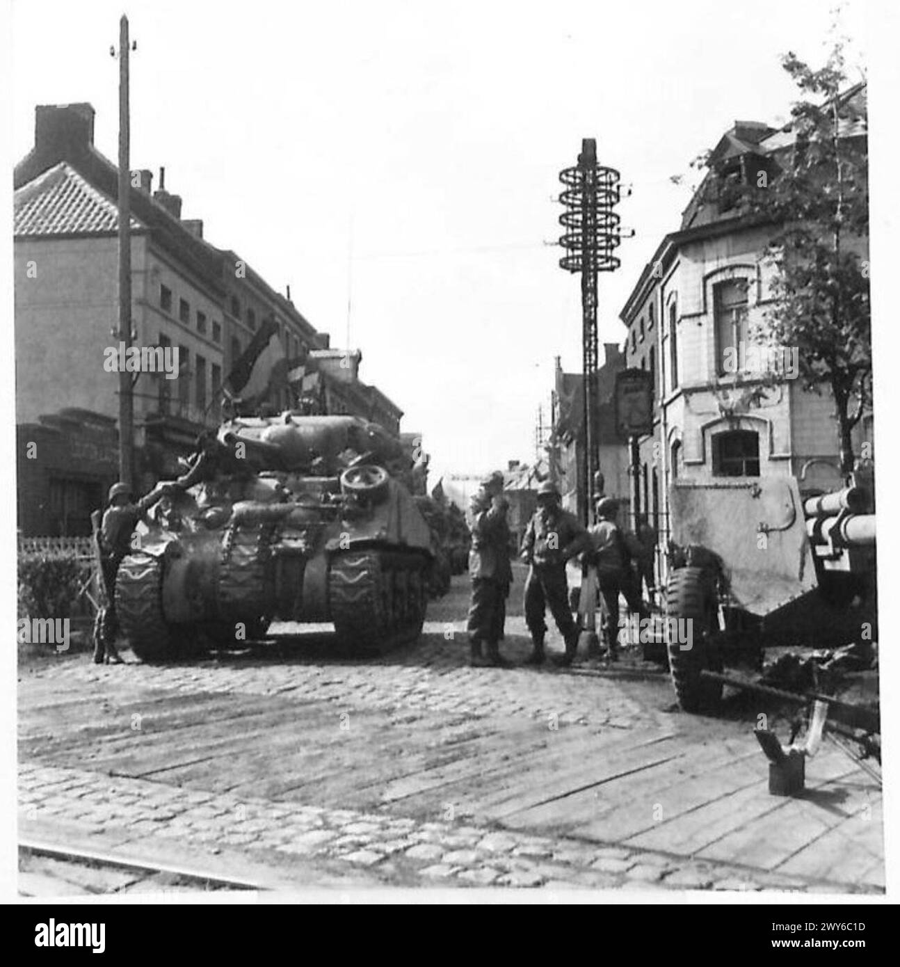 A British tank driver shakes hands with an American infantryman after ...