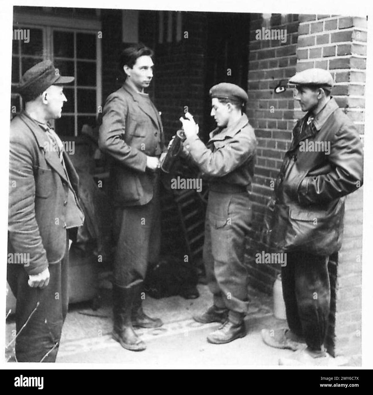 German men are being deloused by members of the Friends Ambulance Unit ...