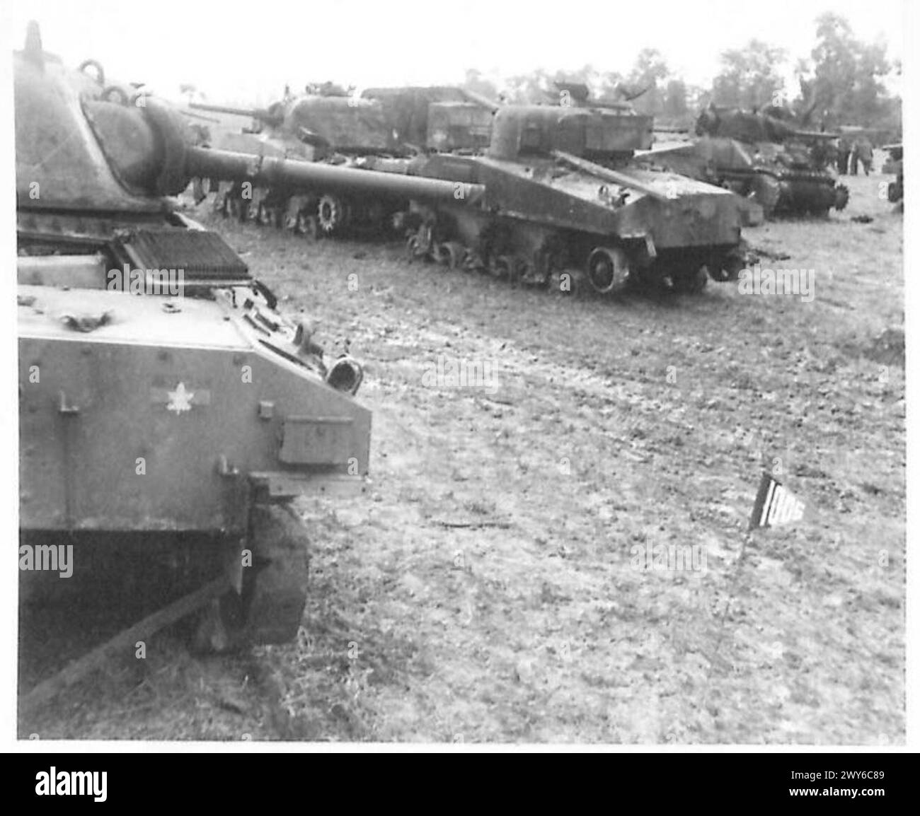 Unserviceable Sherman tanks await repair, documented by the British ...