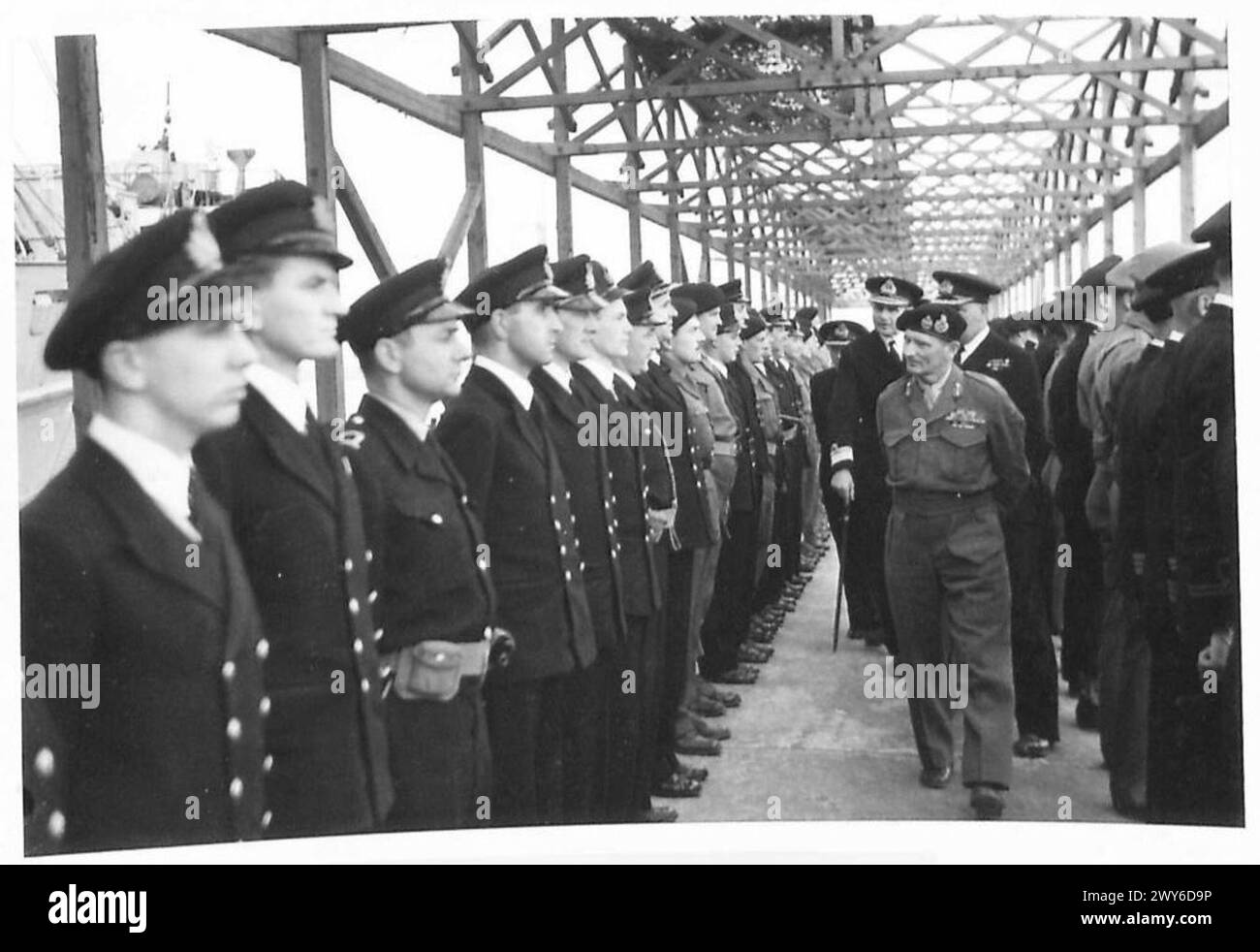 Field Marshal Montgomery, C-in-C, inspects naval personnel on the jetty ...