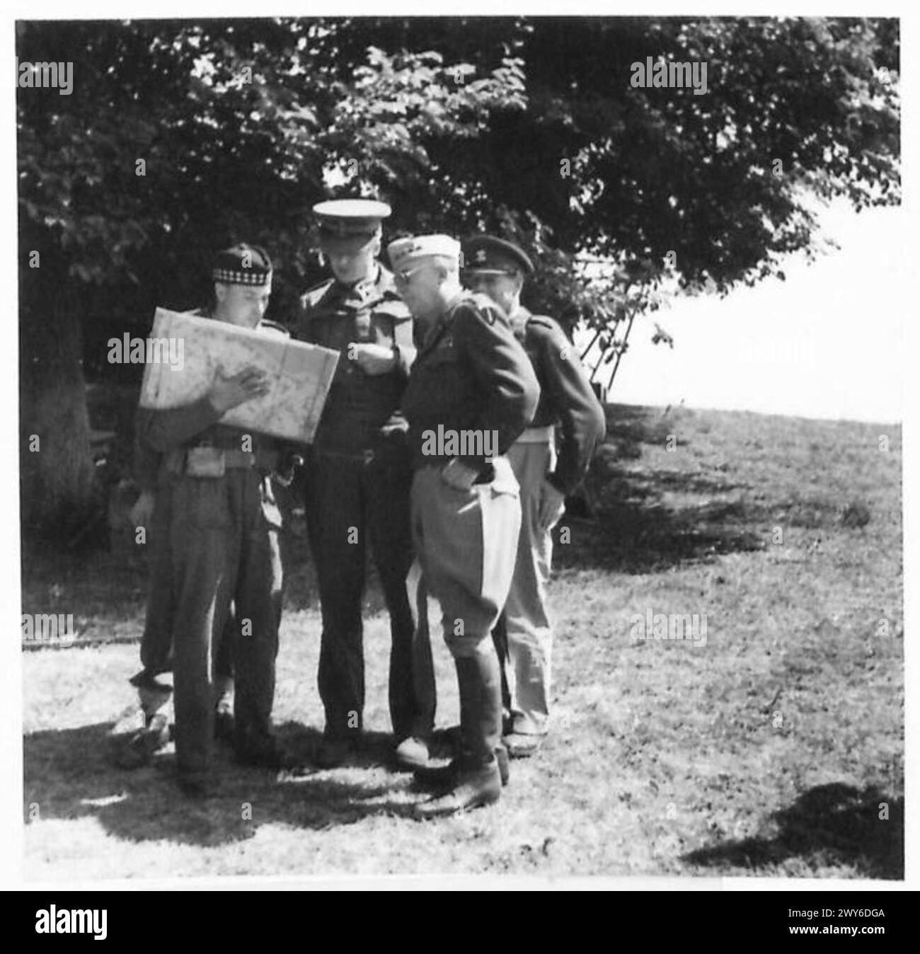 ALLIED CHIEFS MEET IN NORMANDY - General Eisenhower studies a map with ...