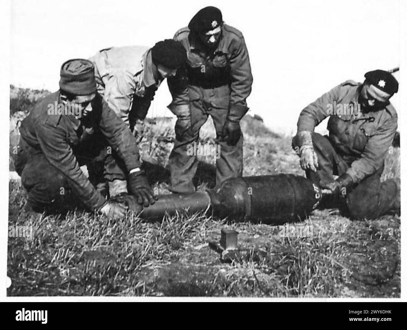 Three Czech soldiers prepare demolition (DO) mines for loading into a ...